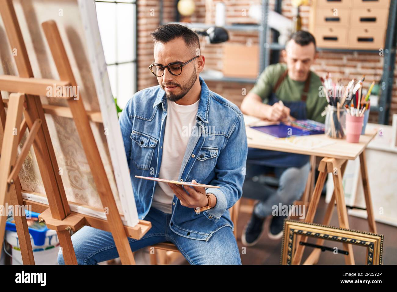 Two men artists drawing at art studio Stock Photo - Alamy