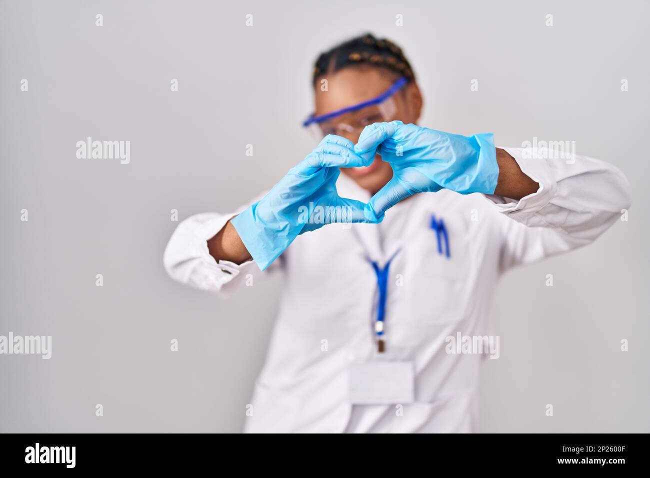 African american woman with braids wearing scientist robe smiling in ...