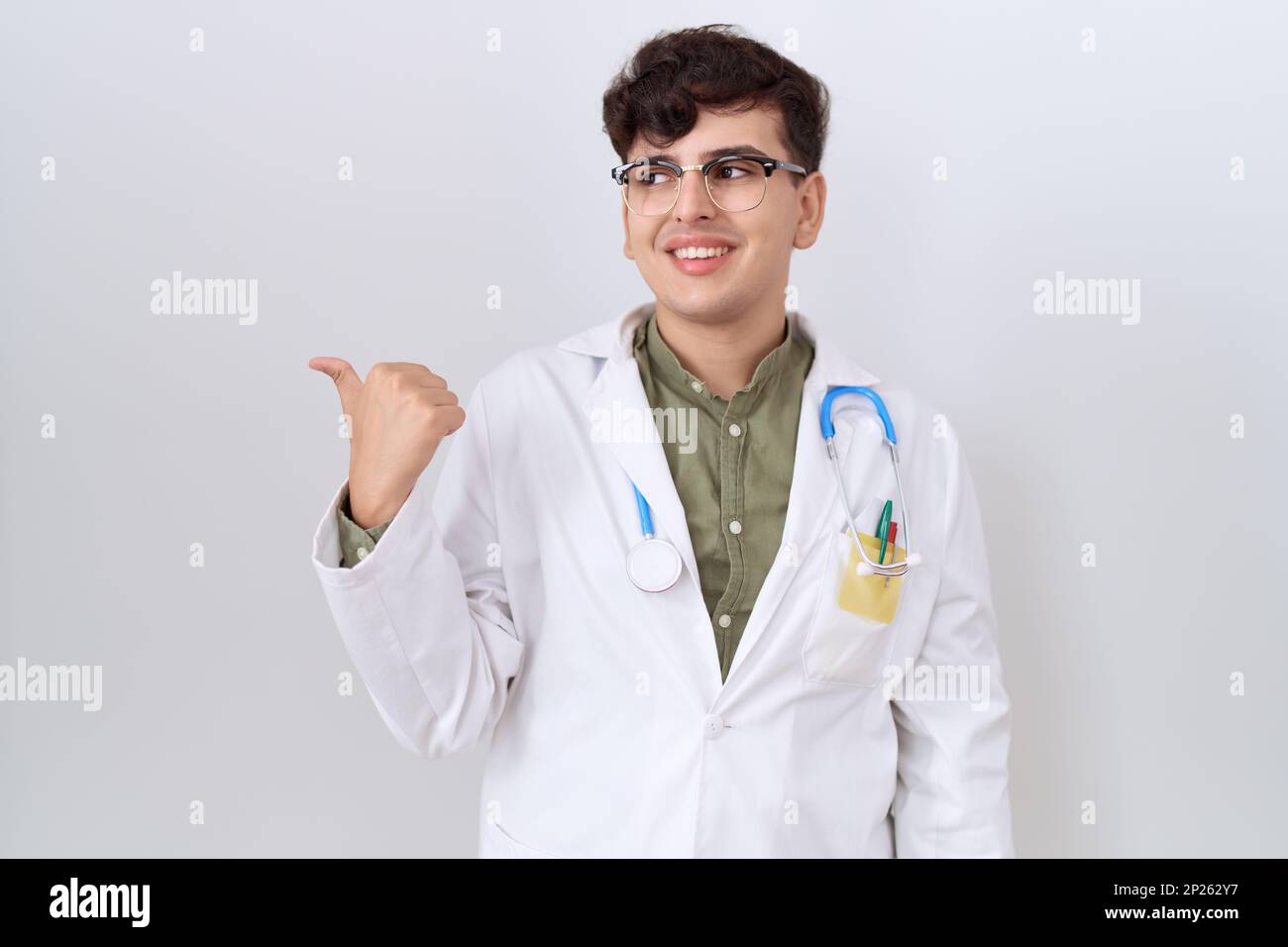 Young non binary man wearing doctor uniform and stethoscope smiling ...