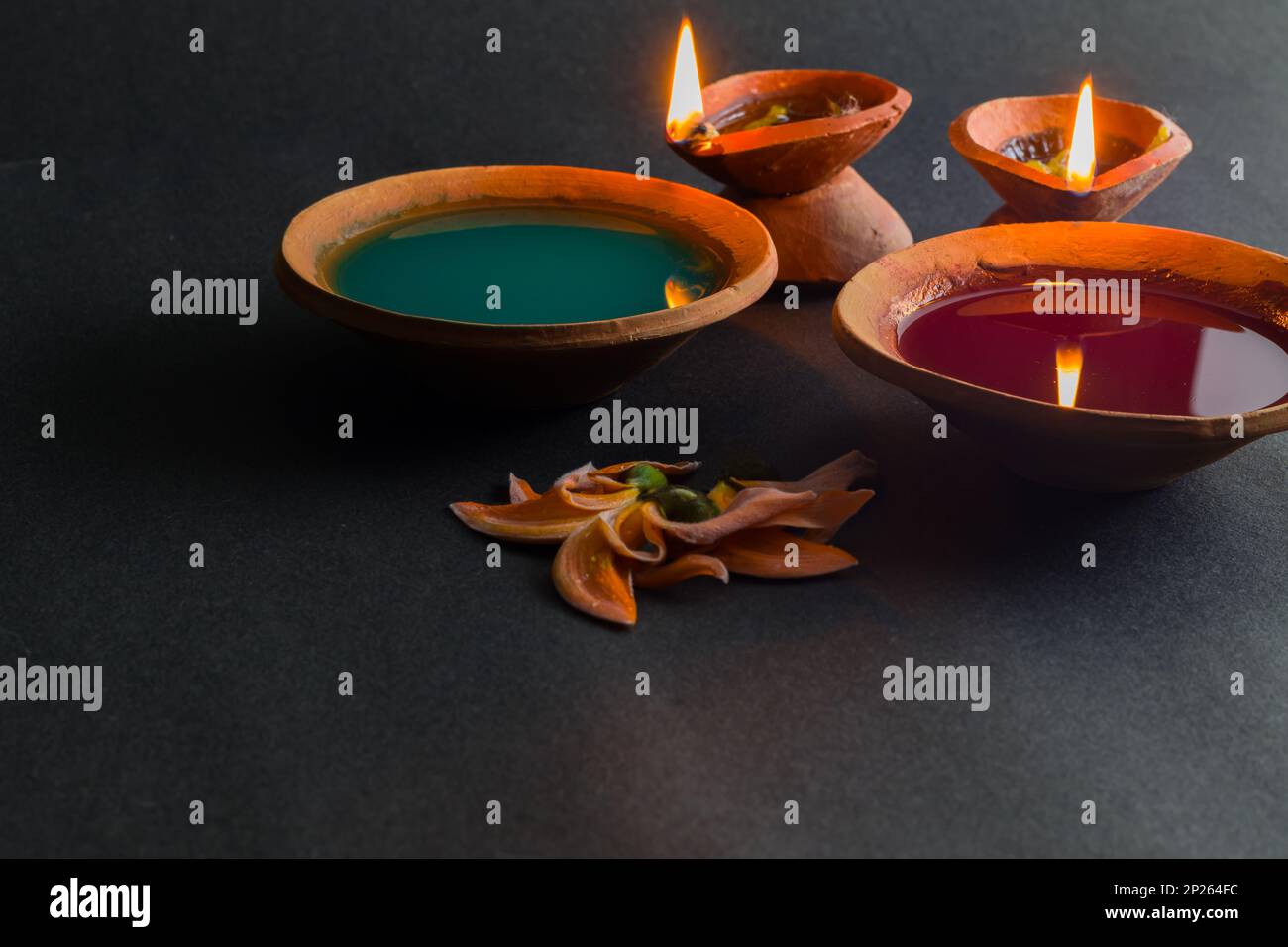 happy holi celebration with colors, clay lamp. Holi or dol yatra is ...