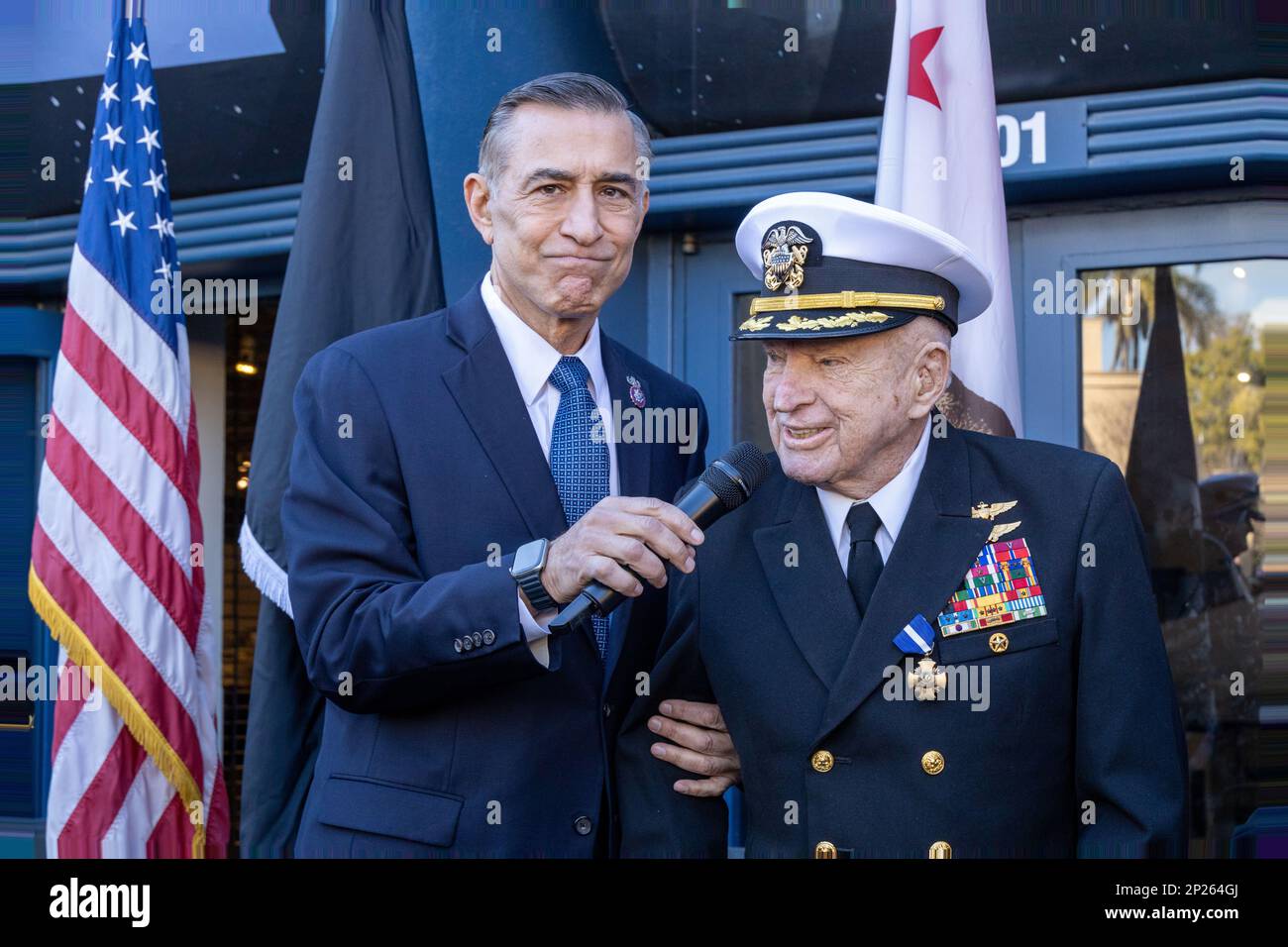 U.S. Rep. Darrell Issa (left) holds the microphone as retired U.S. Navy ...
