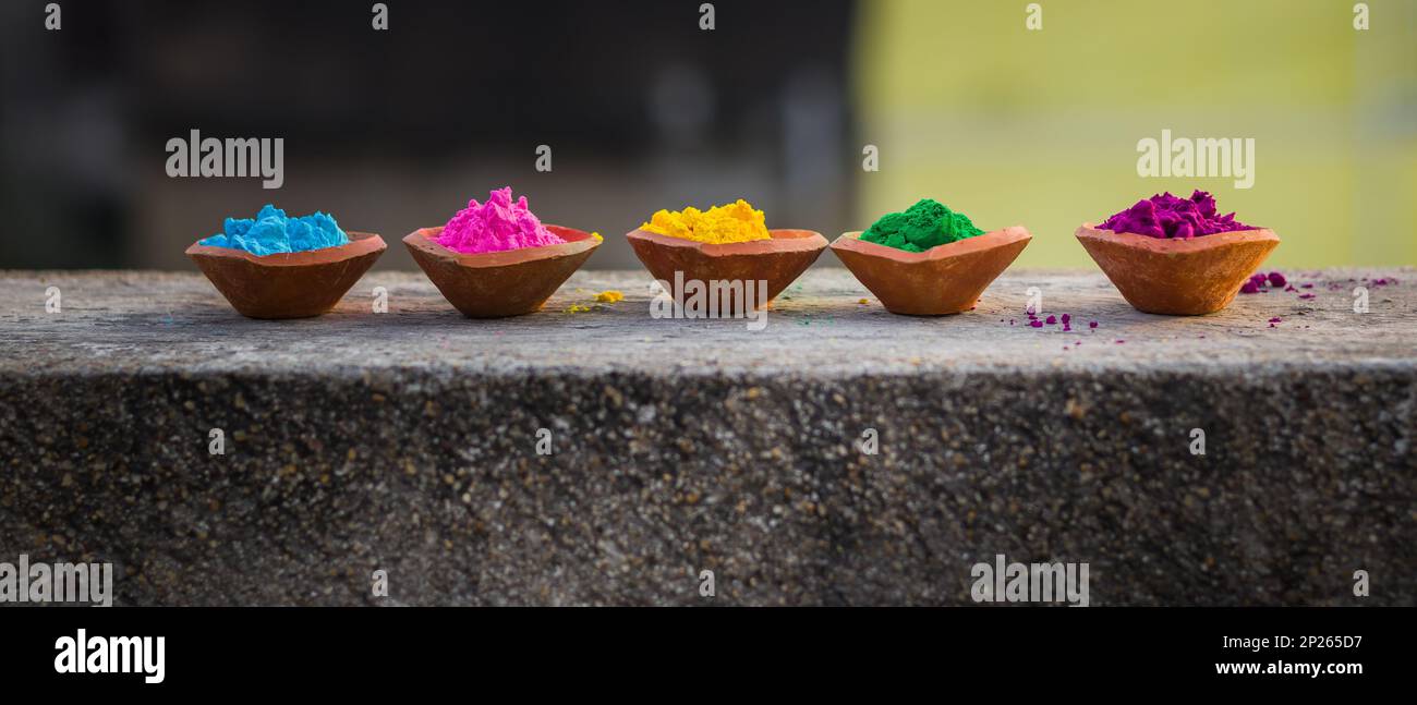 happy holi. gullal or abir, which are colorful powders for holi kept on ...
