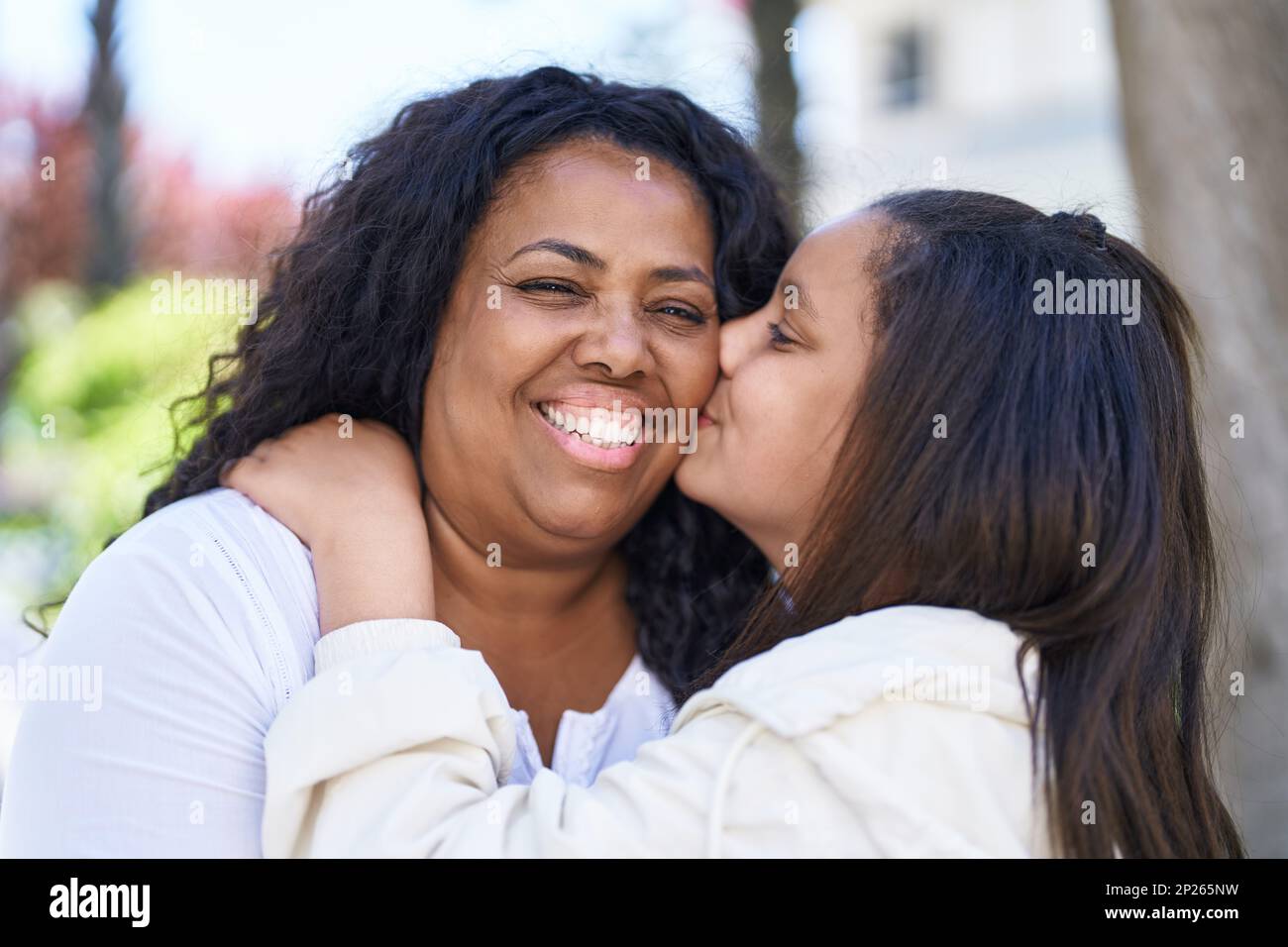 Mother And Daughter Smiling Confident Hugging Each Other And Kissing At