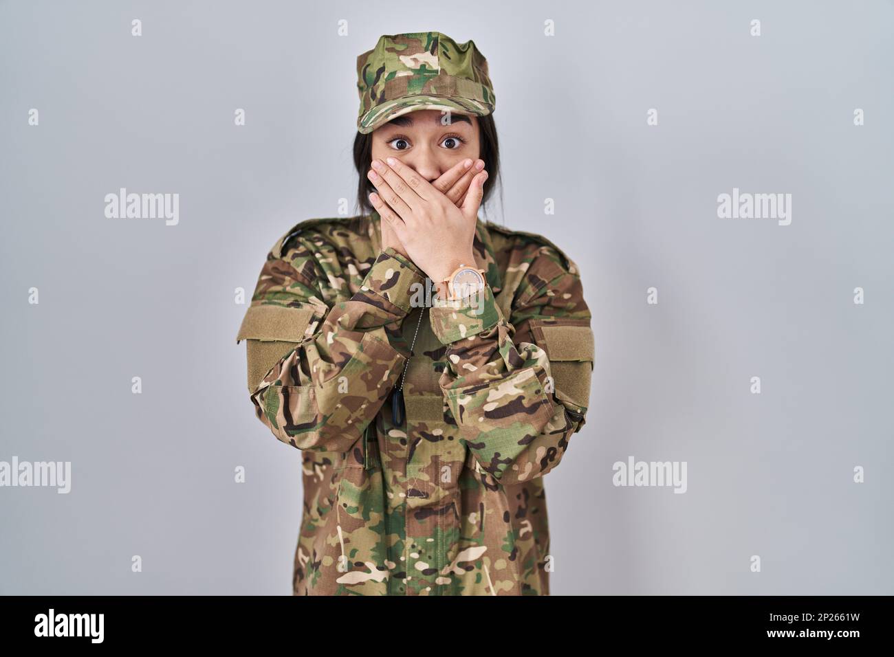 Young south asian woman wearing camouflage army uniform shocked ...