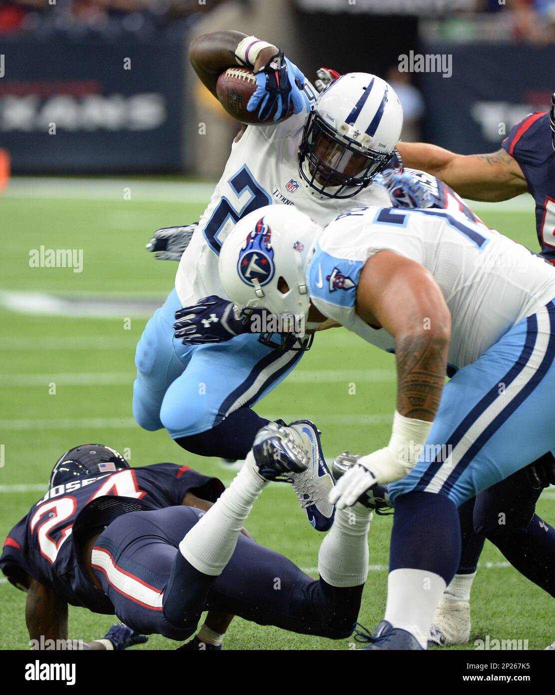Tennessee Titans running back Antonio Andrews (26) is upended by ...