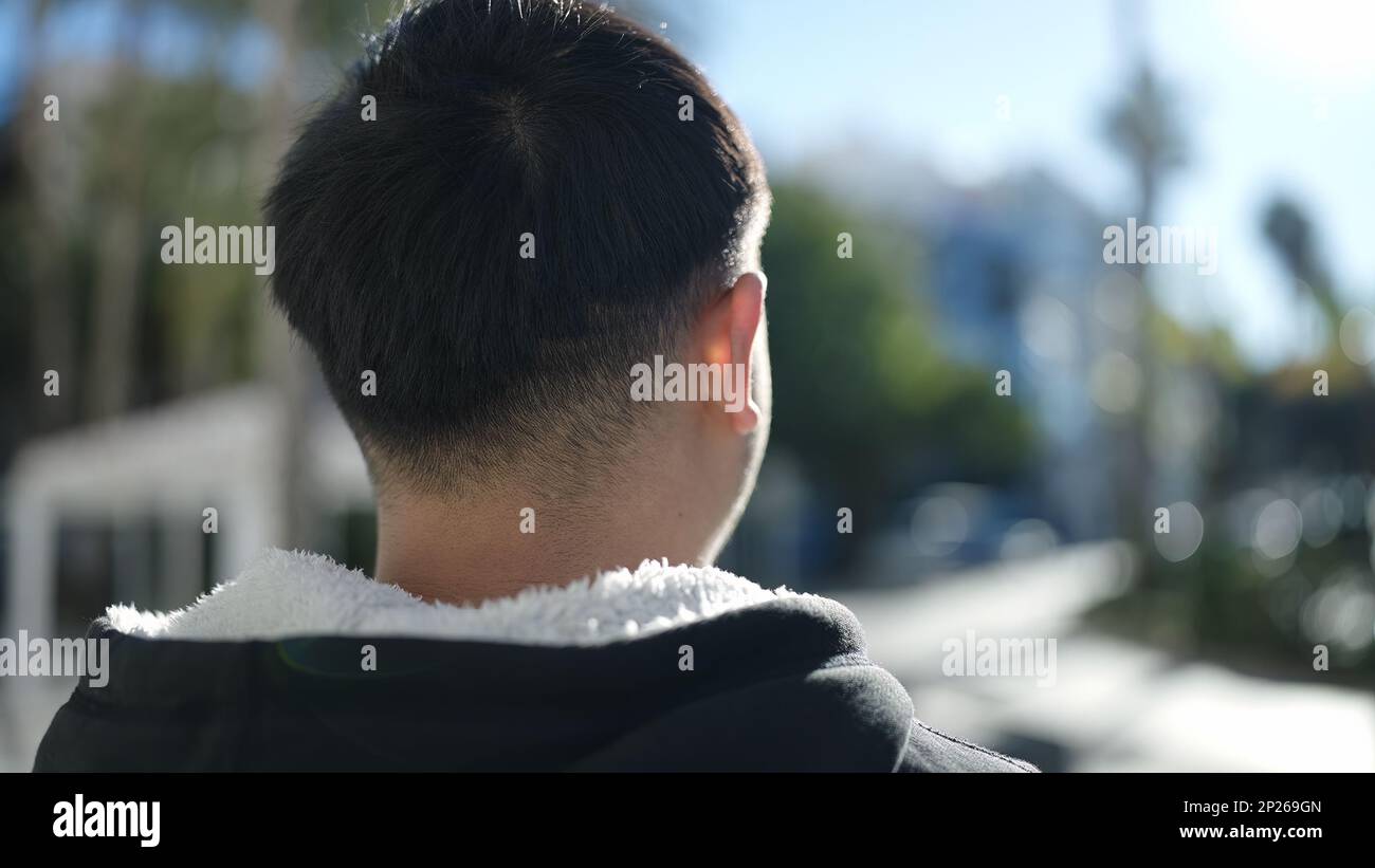 Young chinese man standing on back view at street Stock Photo - Alamy