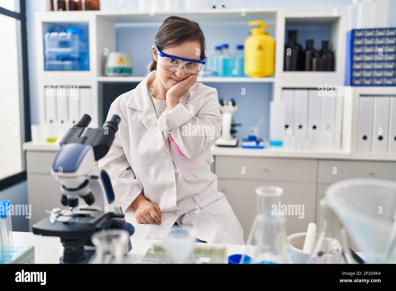 Hispanic girl with down syndrome working at scientist laboratory ...