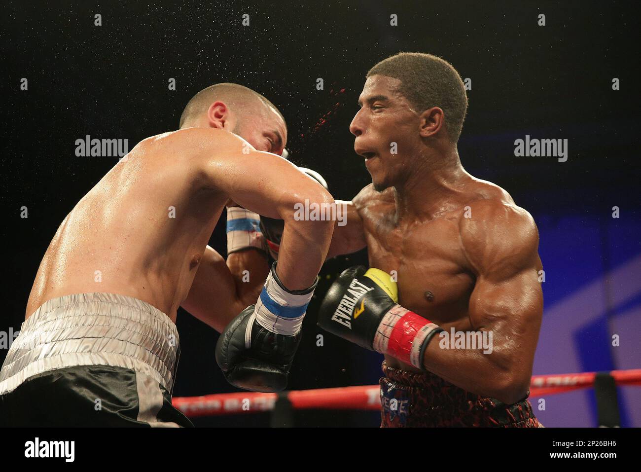 Clarence Booth (R) punches Luis Joel Gonzalez during a Univision ...