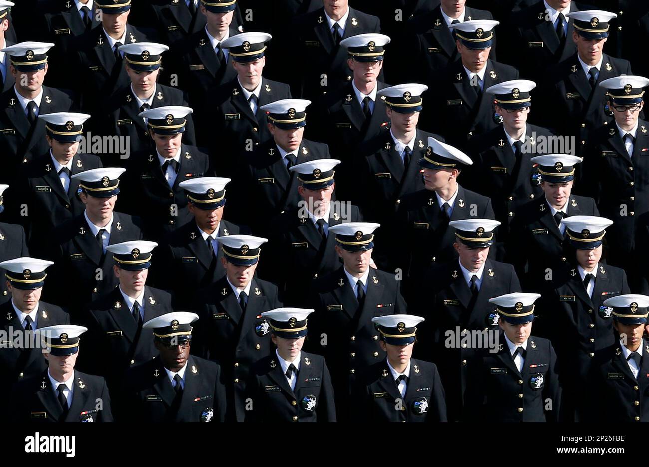 U.S. Naval Academy midshipmen march in formation on the field before an ...