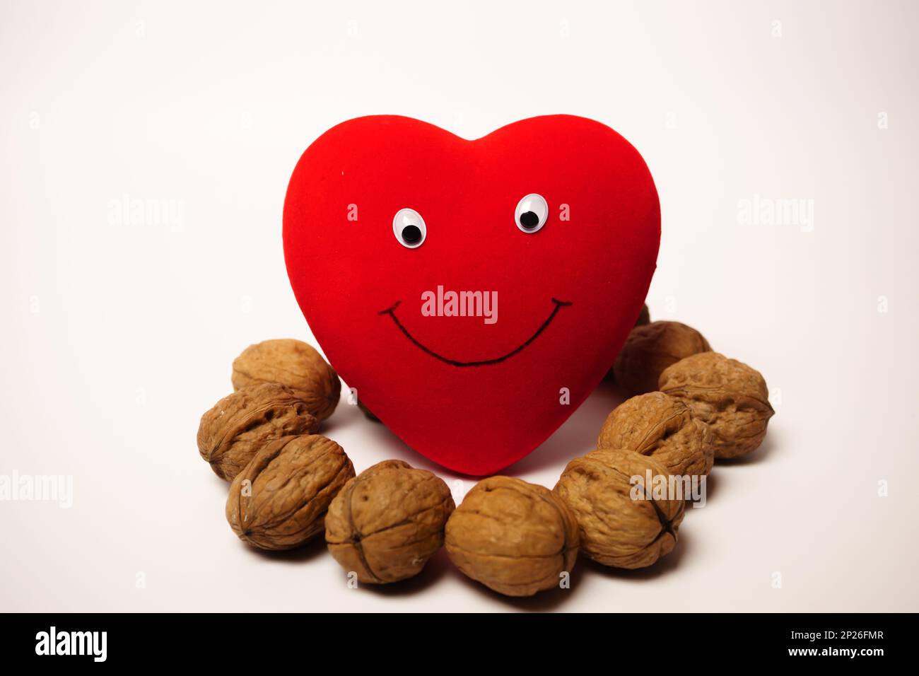 smiling heart with nuts healthy food concept isolated on white ...