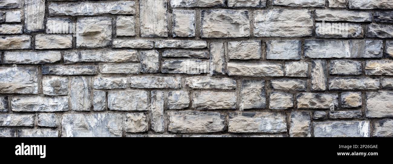 Natural grey stone brick wall texture background banner Stock Photo - Alamy