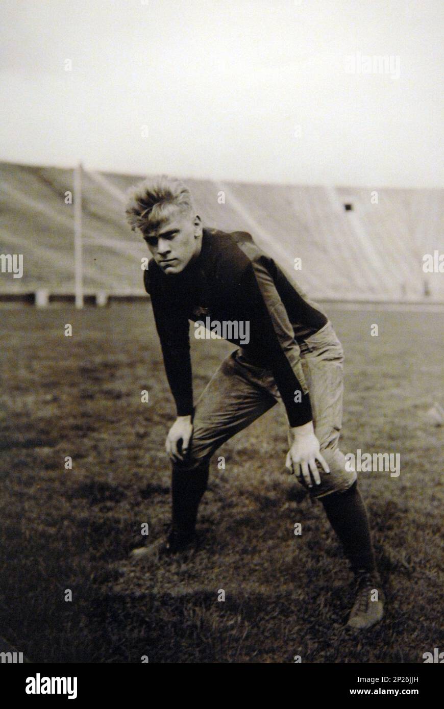 A picture of former president Gerald Ford posing on the football field ...