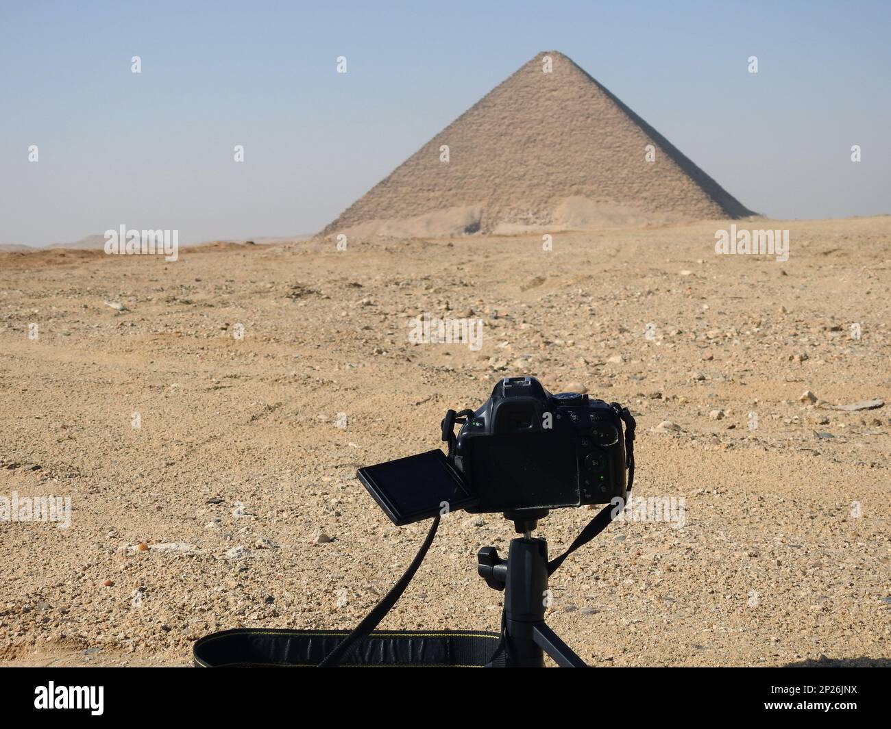 A digital DSLR camera on a tripod Photographing The red north pyramid ...