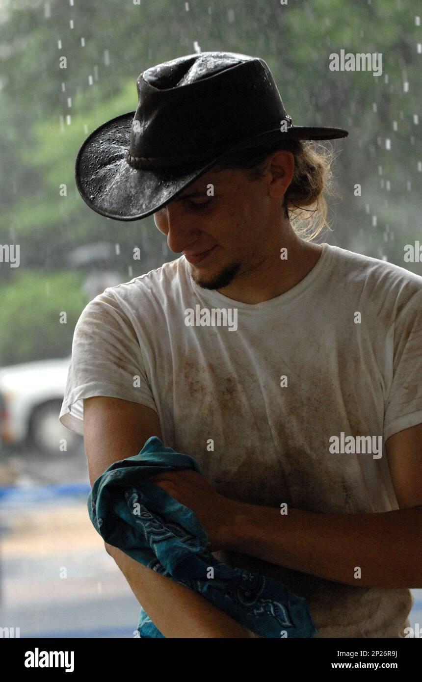 Stephen Browning of Charleston, S.C., washes off with rain water at the ...