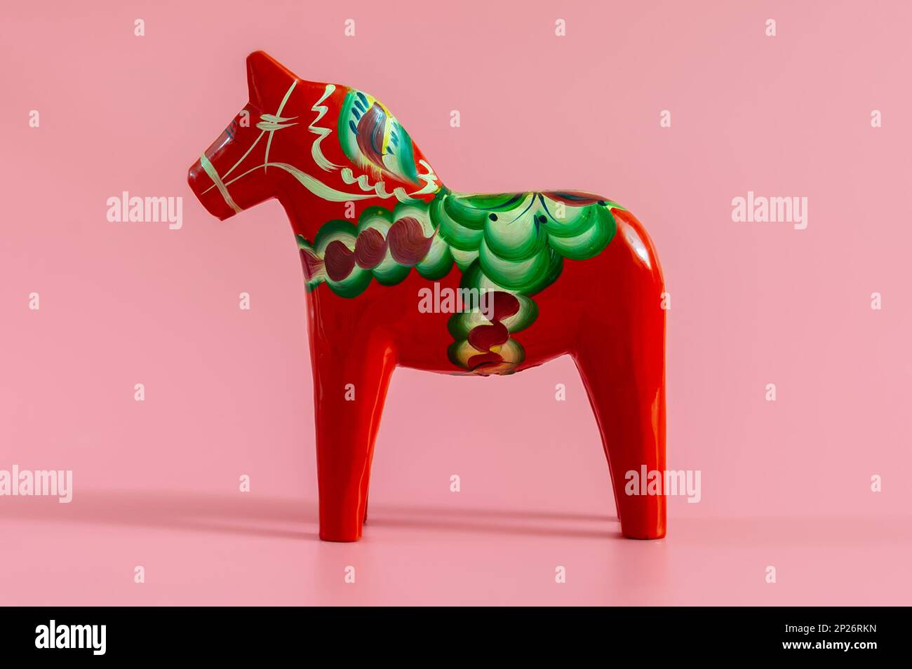A Red, Swedish Wooden Dala Horse with a pink background Stock Photo - Alamy