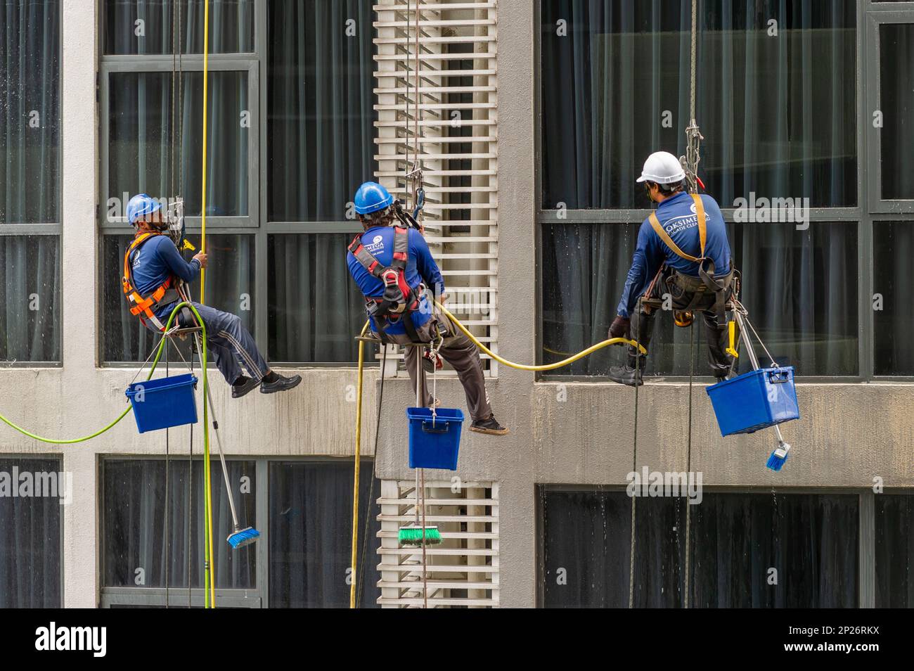 Men cleaning windows of a tall building from the outside Stock Photo ...