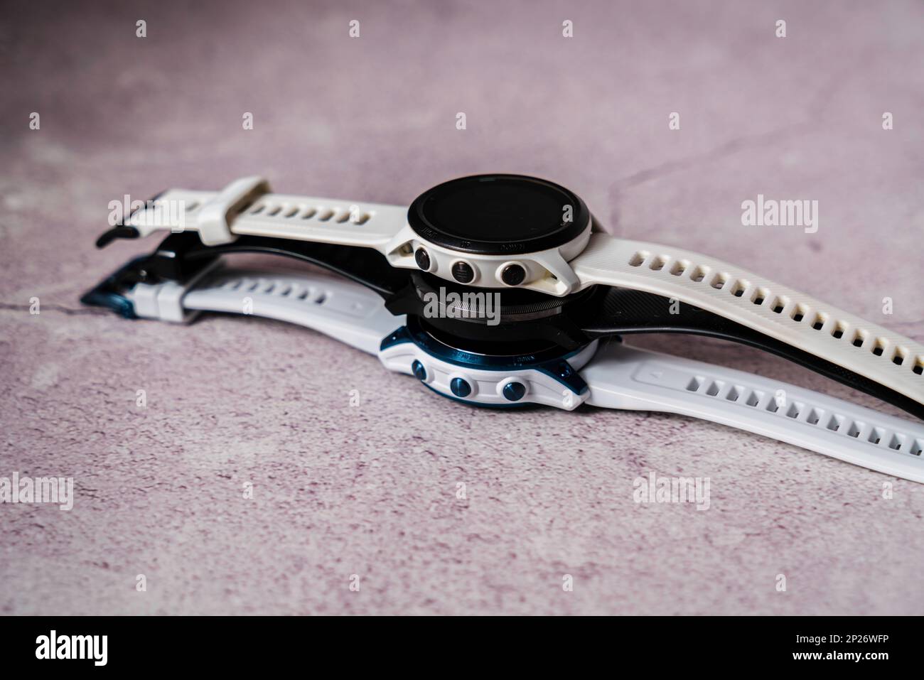 Kyiv, Ukraine - 11.01.2023: Garmin Fenix 7 Saphire Solar blue color vs ... Kyiv, Ukraine - 11.01.2023: Garmin Fenix 7 Saphire Solar blue color vs ...