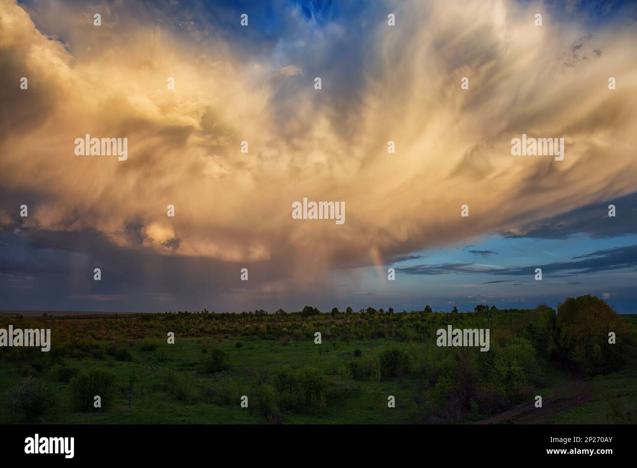 a storm cloud after rain over the valley, and a rainbow Stock Photo - Alamy