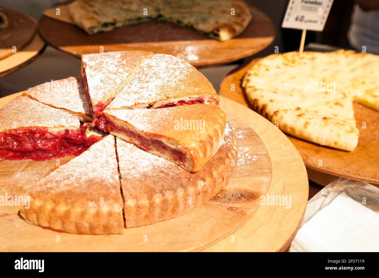 Sliced various pies at food market. Pieces of cut-up fruit pie Stock ...