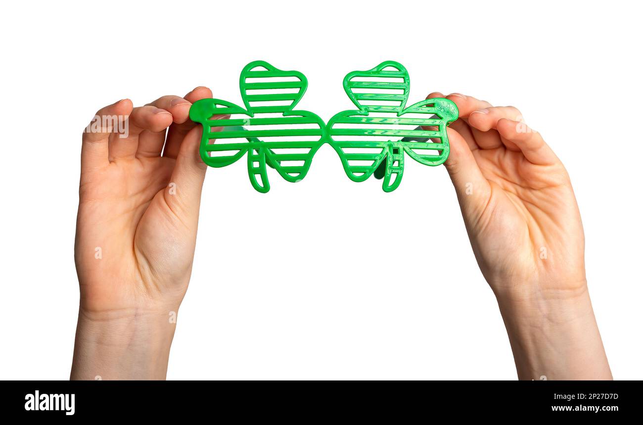 Clover-shaped glasses, green leaf eyewear, eye decoration in hands ...