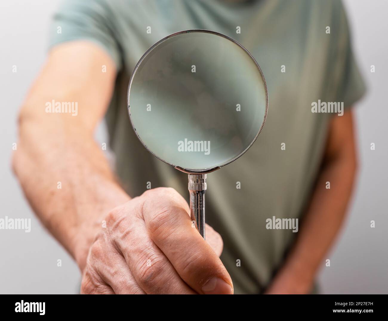 Hand holding magnfier. Looking through magnifying glass lens. Search ...