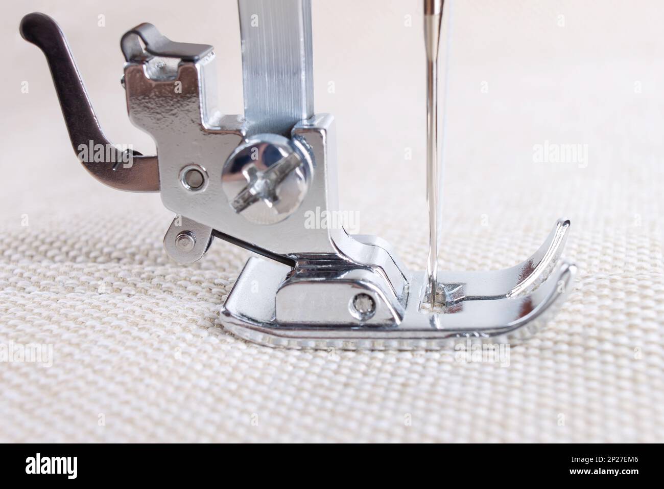 Modern sewing machine presser foot with linen fabric and thread ...