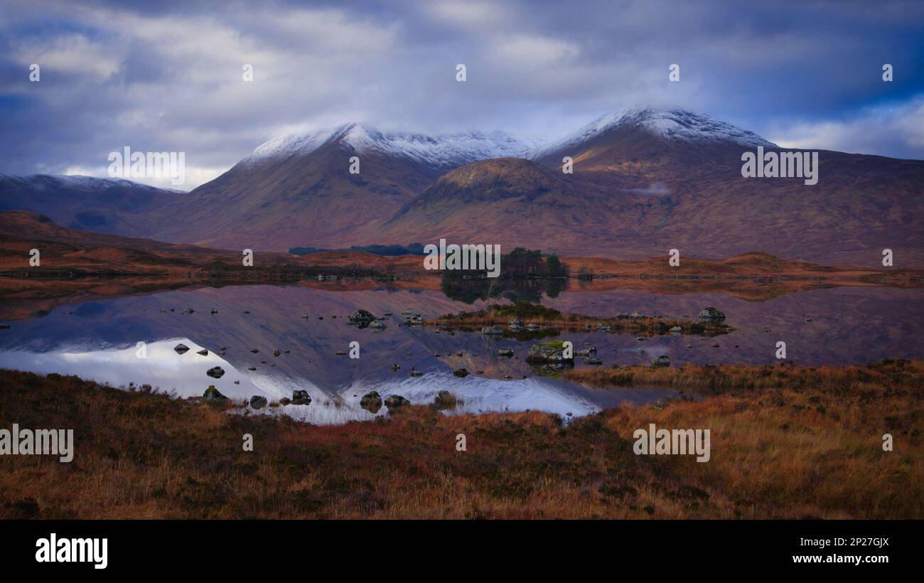 Reflections of the snow tipped mountains in Glencoe in Scotland Stock ...