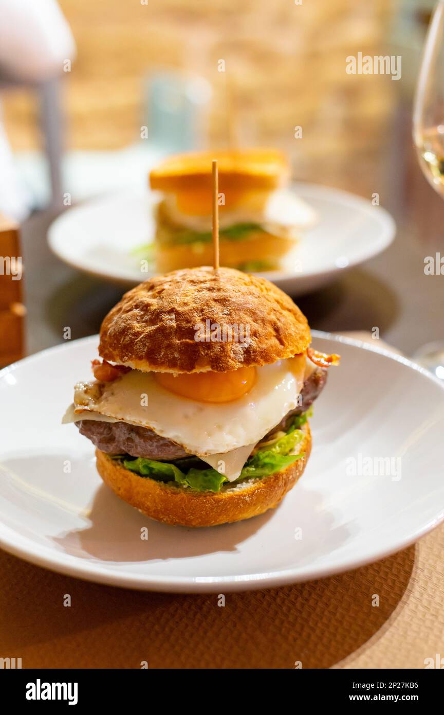 Tasty burger made with white crispy ban, beef burger, egg, green ...