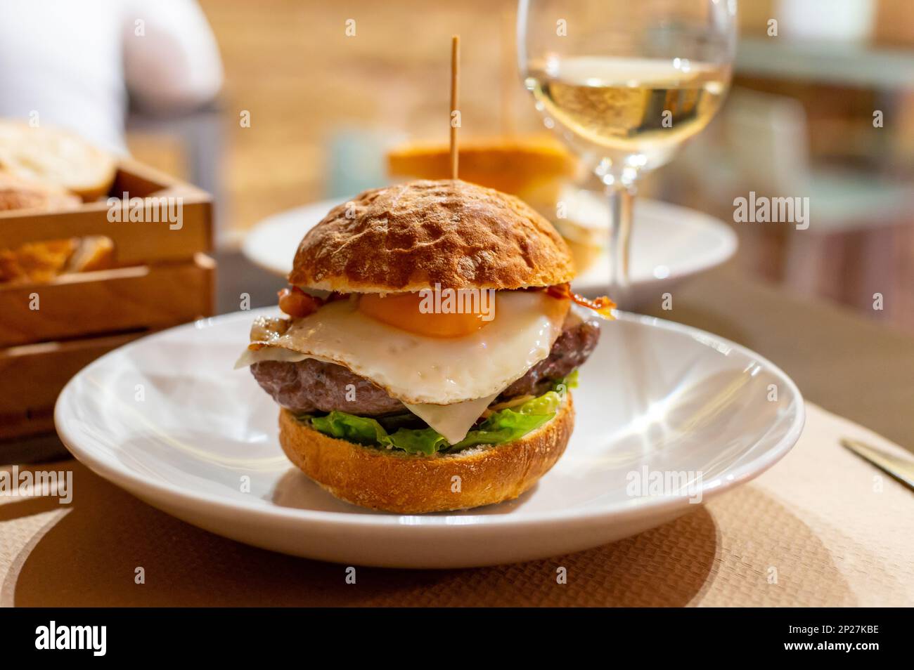 Tasty burger made with white crispy ban, beef burger, egg, green ...
