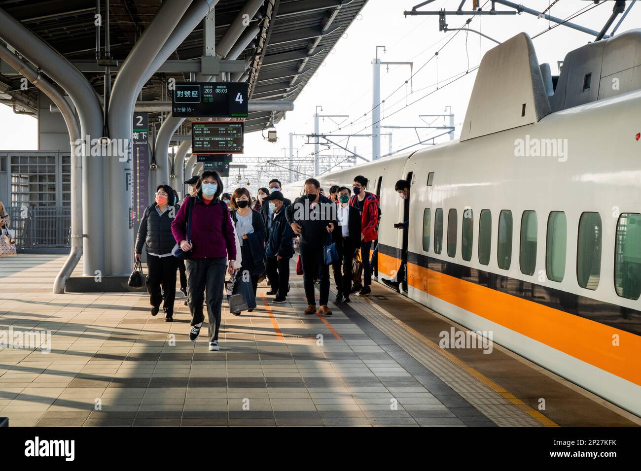 Passengers get on and off the Taiwan High Speed Rail (THSR) line from ...