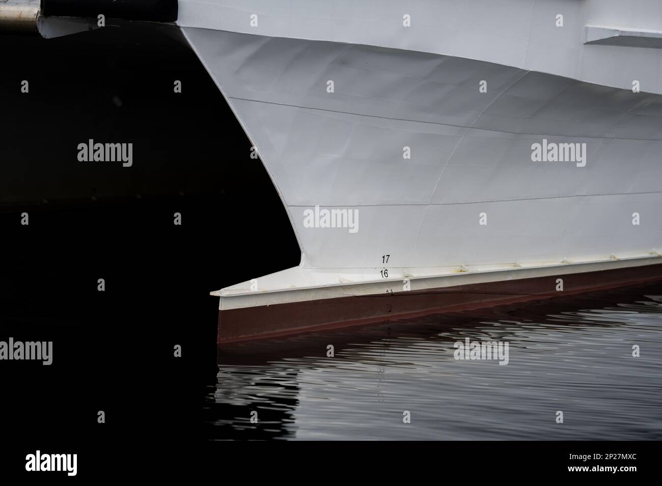 An image of an old white ship situated in a calm, blue body of water ...