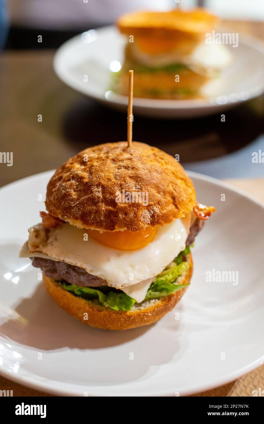 Tasty burger made with white crispy ban, beef burger, egg, green ...