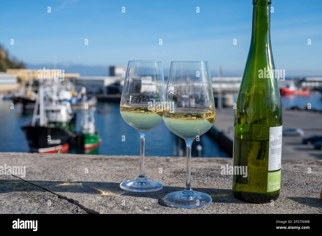Tasting of txakoli or chacolí slightly sparkling very dry white wine ...