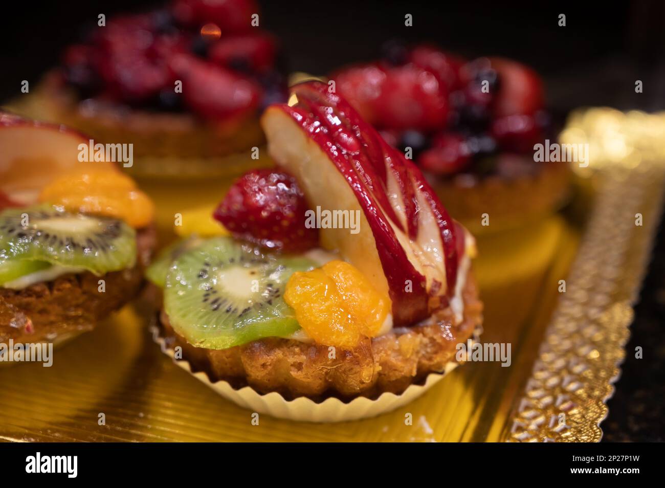 Delicious fresh baked colorful decorated cakes, tarts with cream and ...