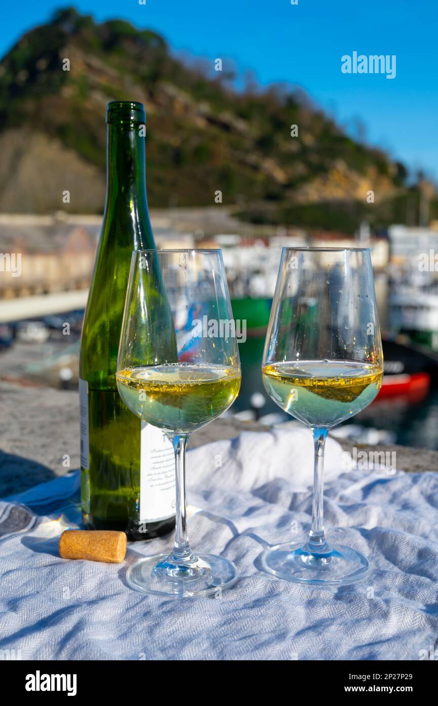 Tasting of txakoli or chacolí slightly sparkling very dry white wine ...