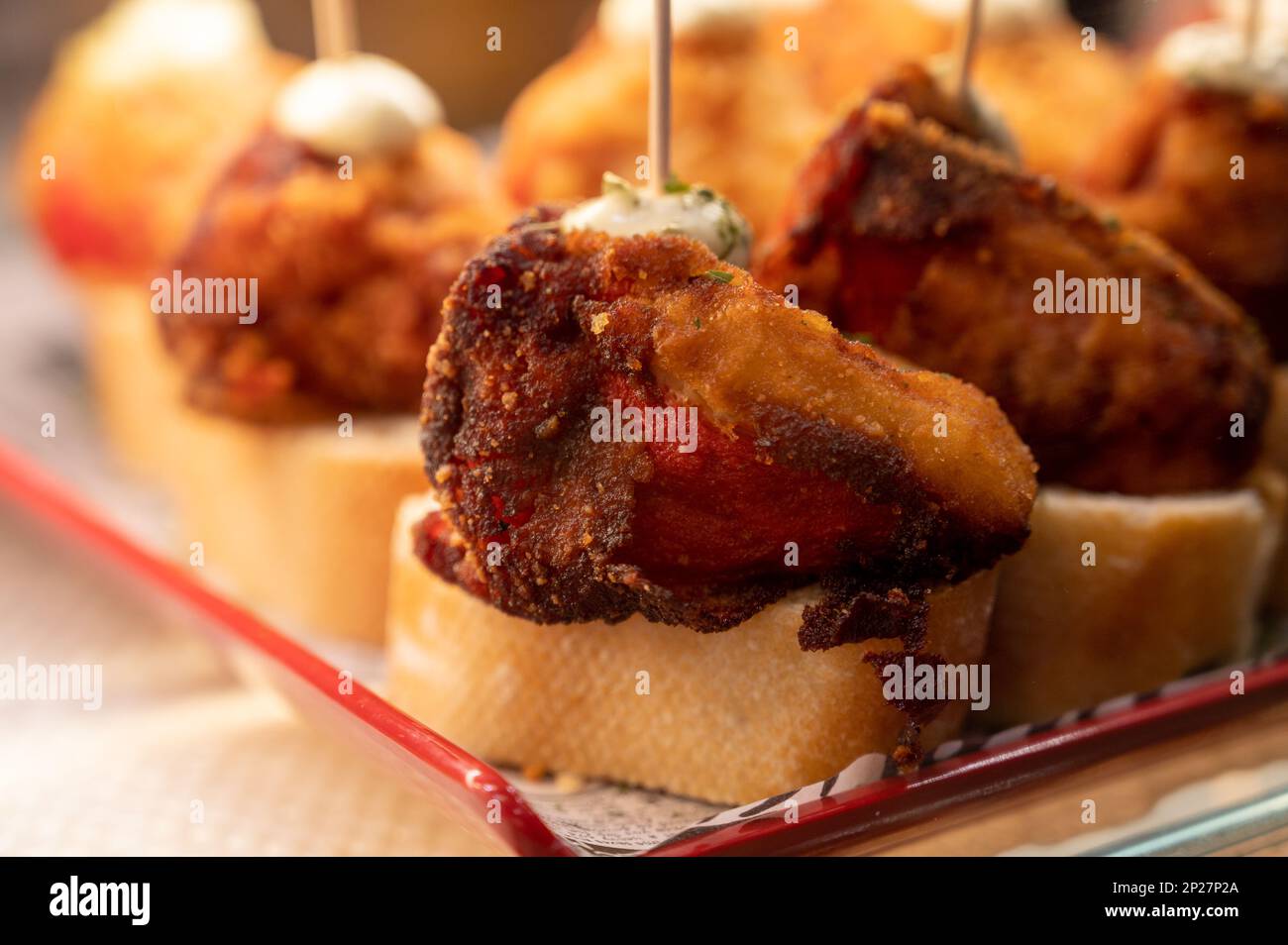 Typical snack of Basque Country, pinchos or pinxtos skewers with small ...