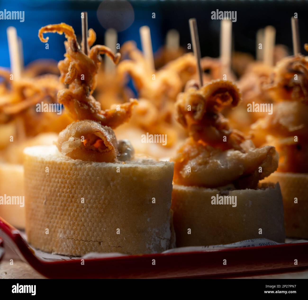 Typical snack of Basque Country, pinchos or pinxtos skewers with small ...