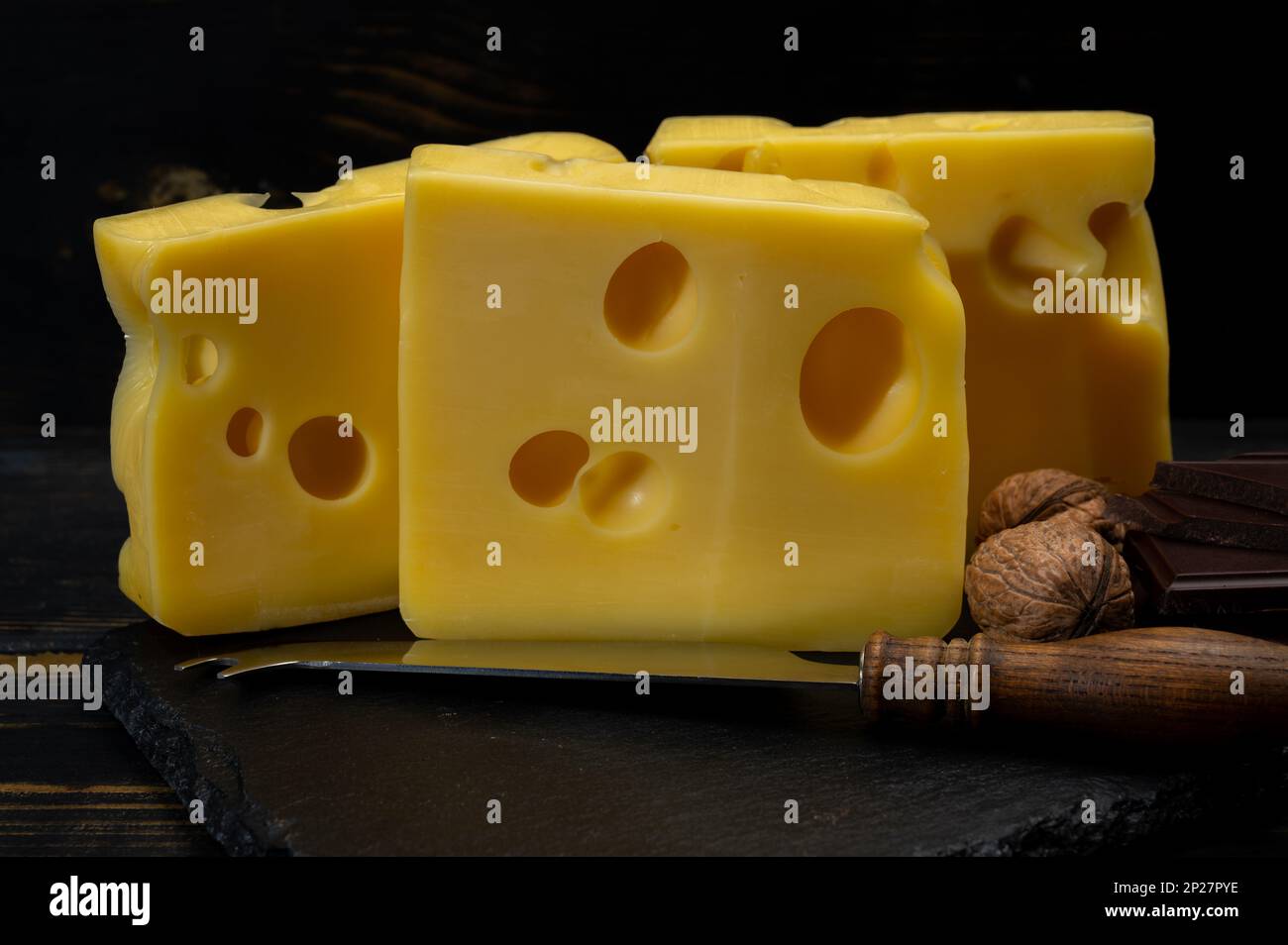 Swiss food, medium-hard cow milk cheese emmentaler with holes, dark ...