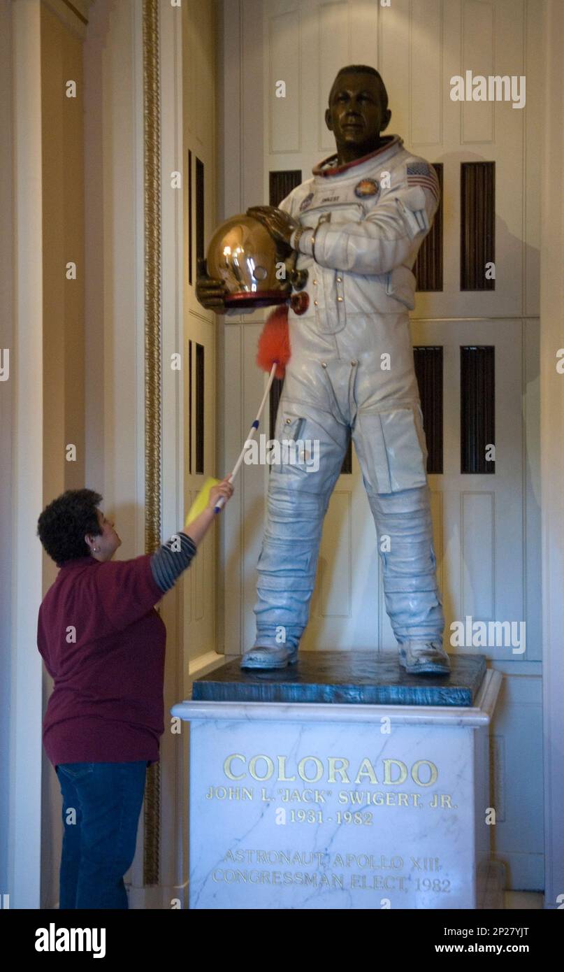 A worker in the Capitol, who refused to be identified, dusts the statue ...