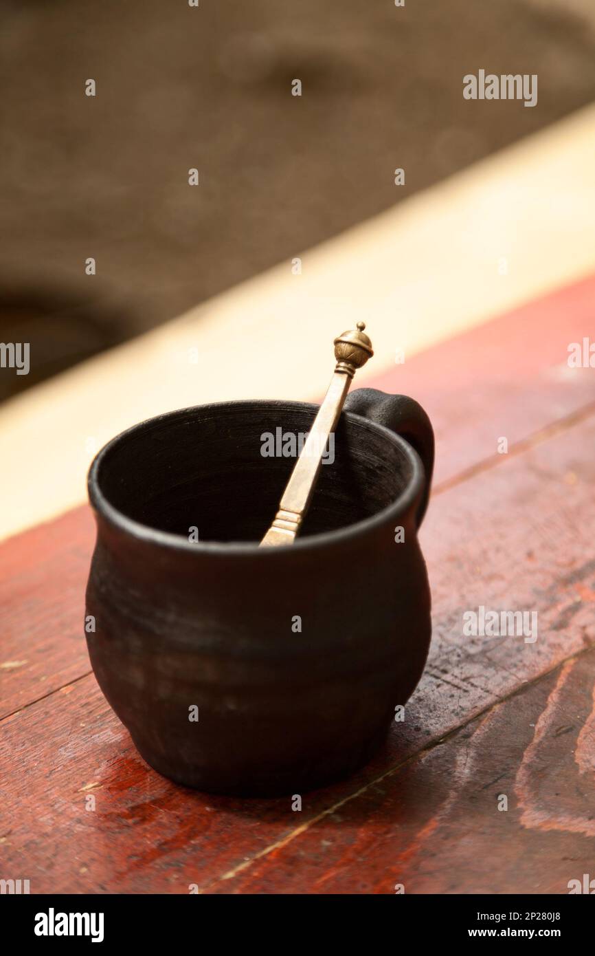 Replica of antique medieval ceramic mug with a spoon. Middle Ages ...