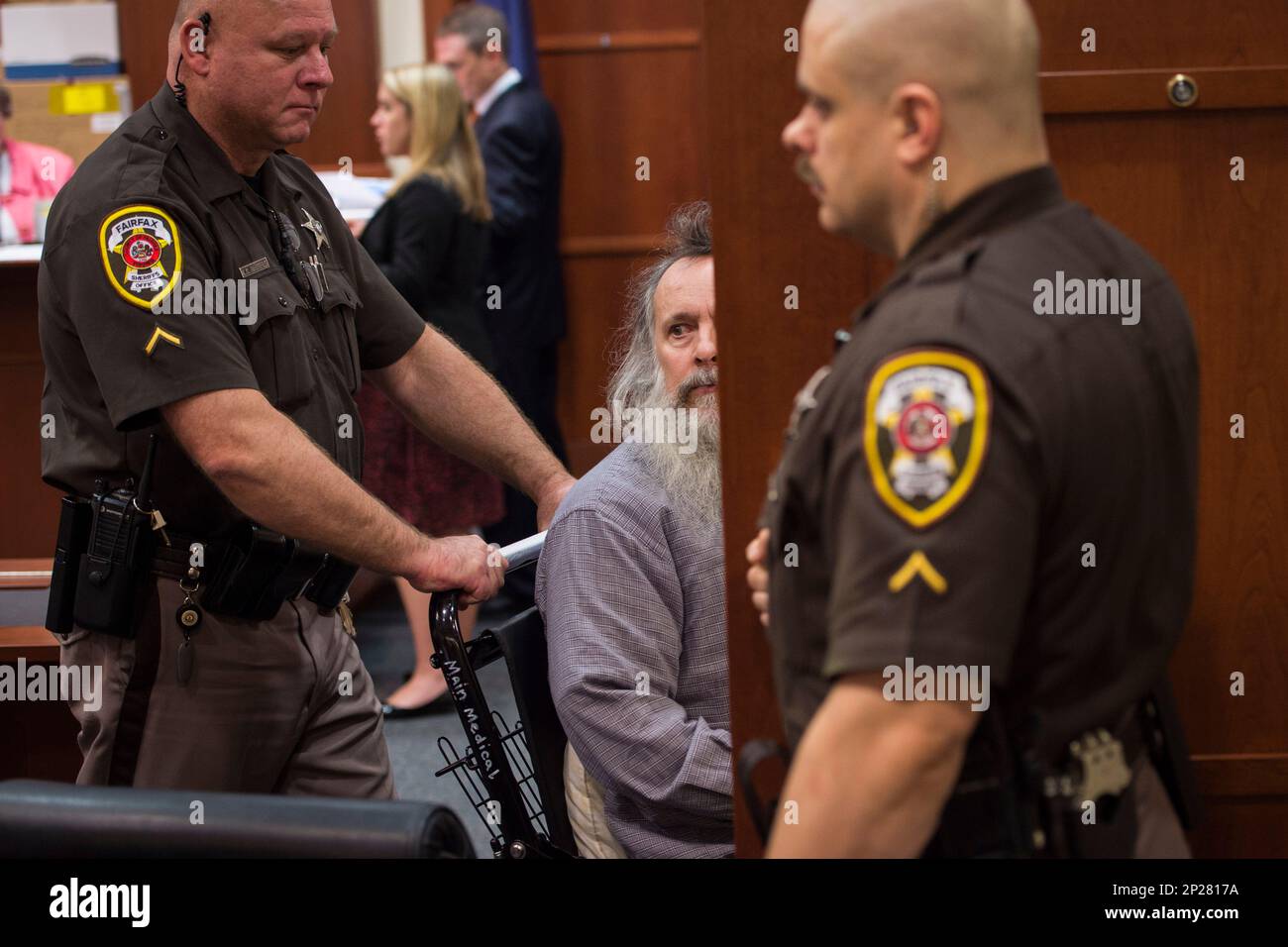 Charles Severance looks out to the gallery as he is taken out of the ...