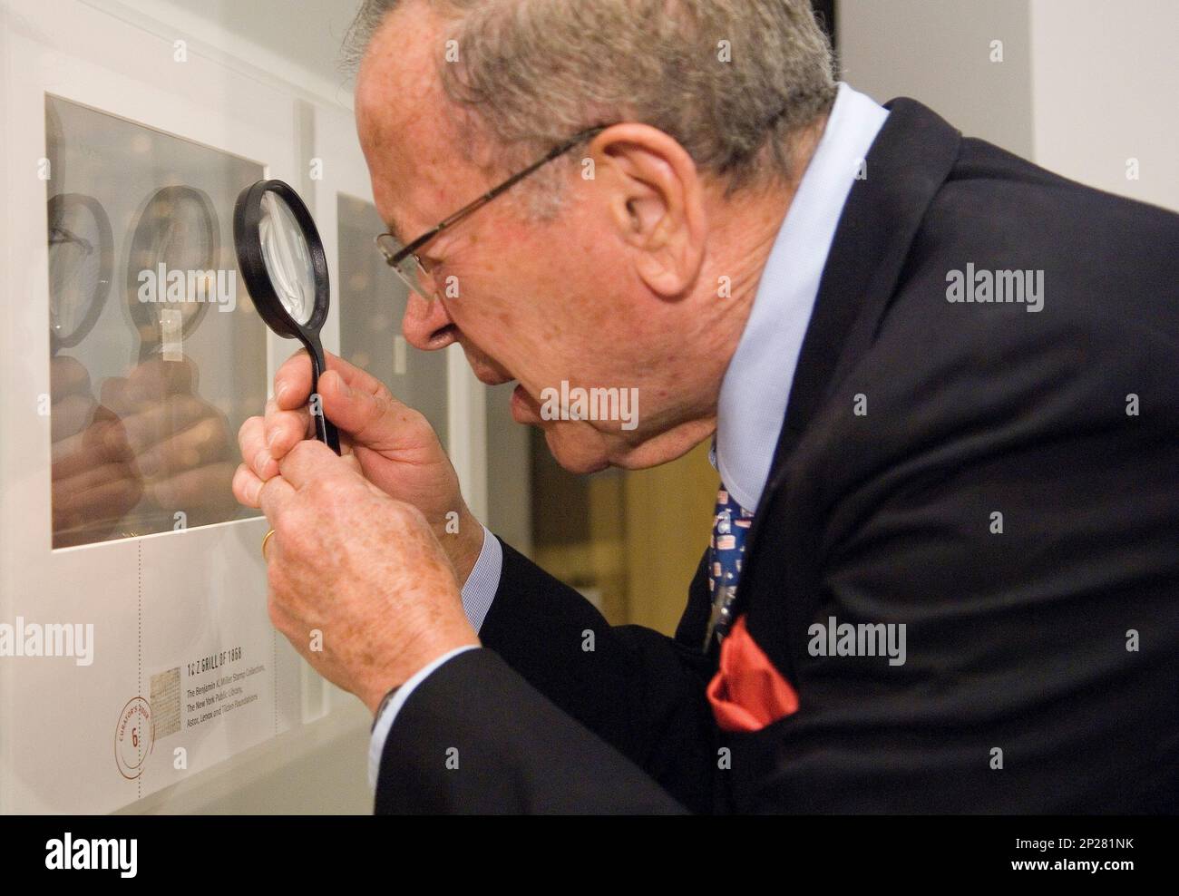Sen. Ted Stevens, R-Alaska, uses a magnifying glass to examine the very ...