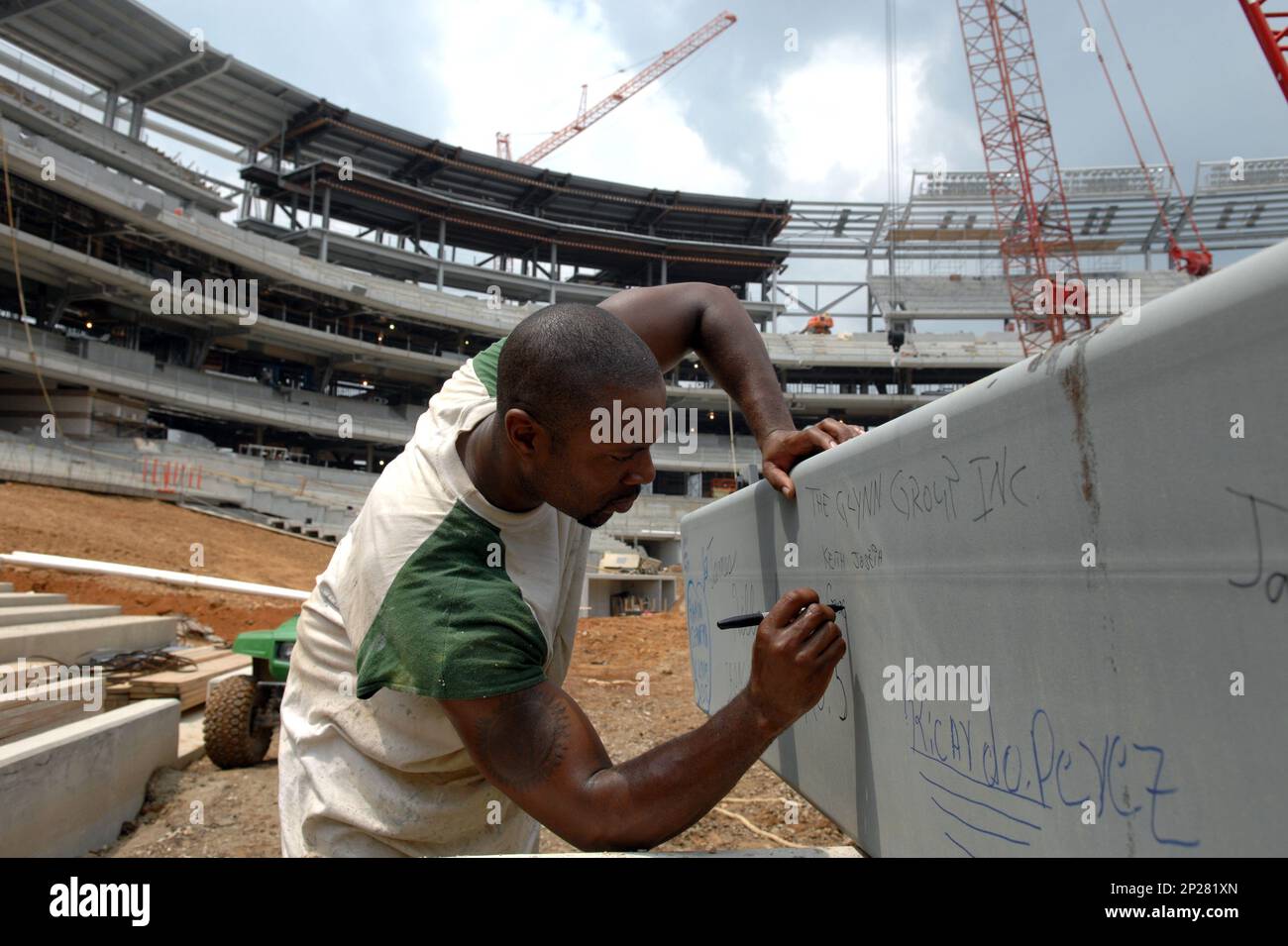George Harris, a painter at the site of the new baseball stadium, signs ...