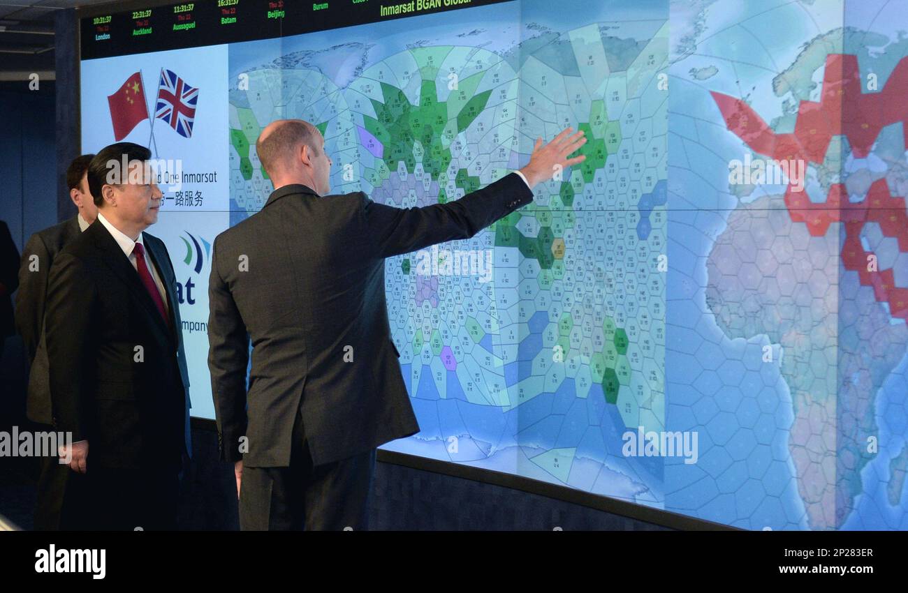 Chinese President Xi Jinping, left, views satellite coverage screens in the Network Operation ...
