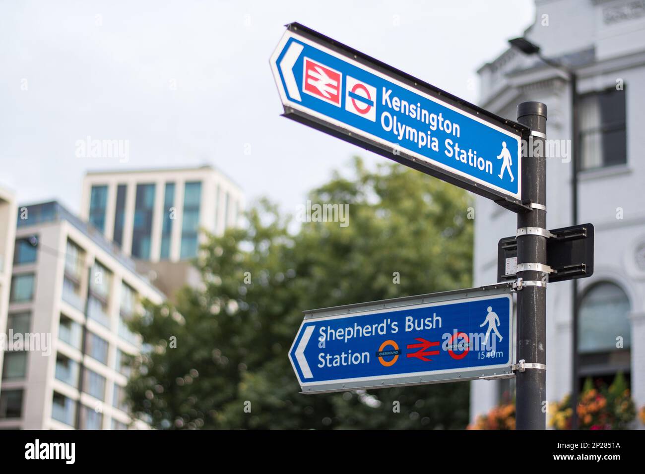 A road sign on a street in London gives directions to pedestrians ...