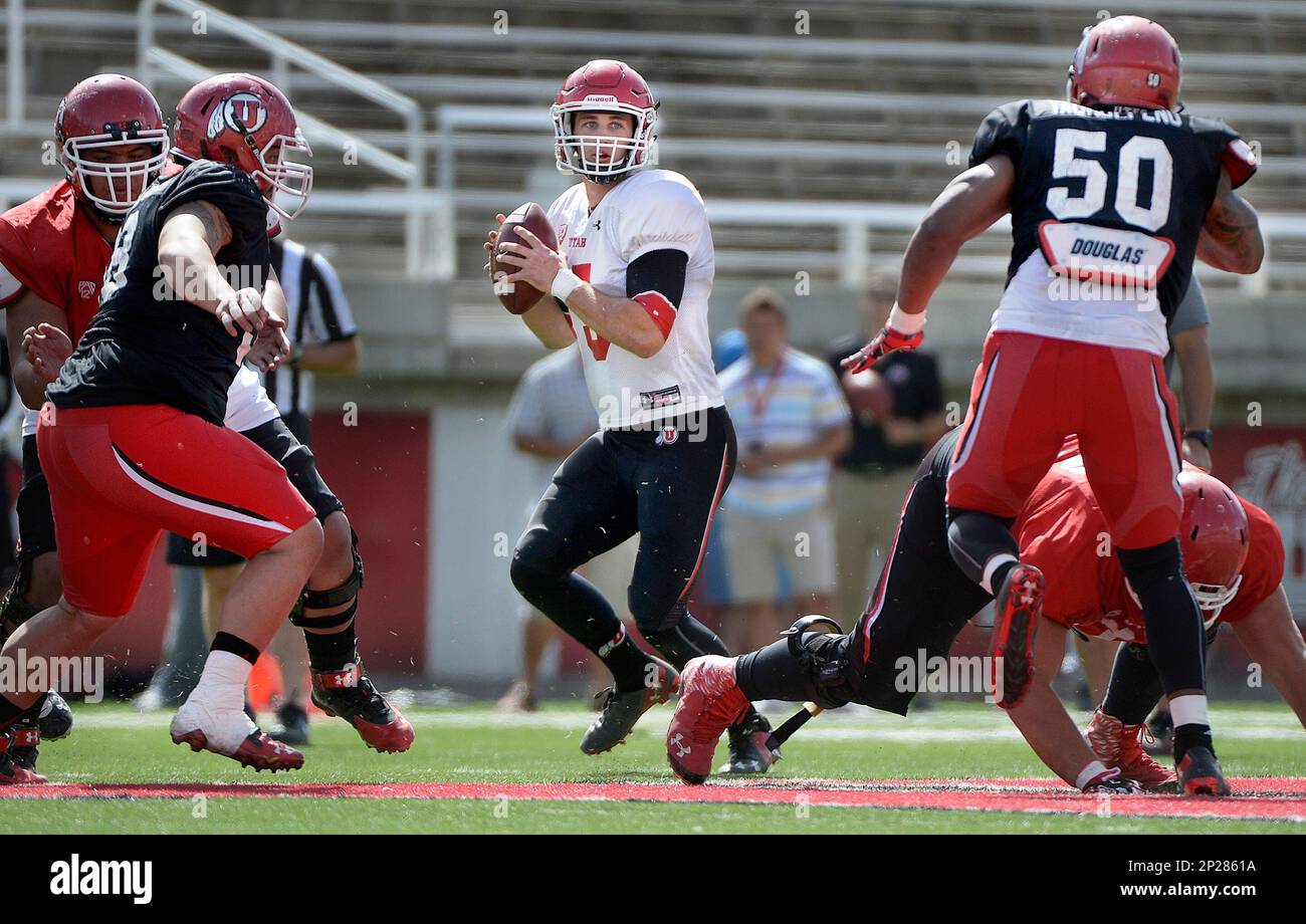 In this April 11, 2015 photo, Utah quarterback Chase Hansen looks to ...