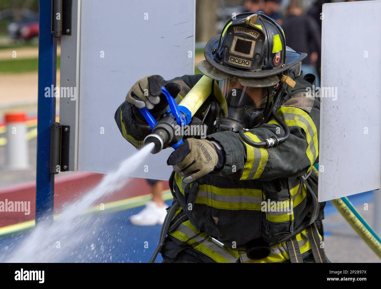 A firefighter hits a target with a water hose during the Firefighter ...