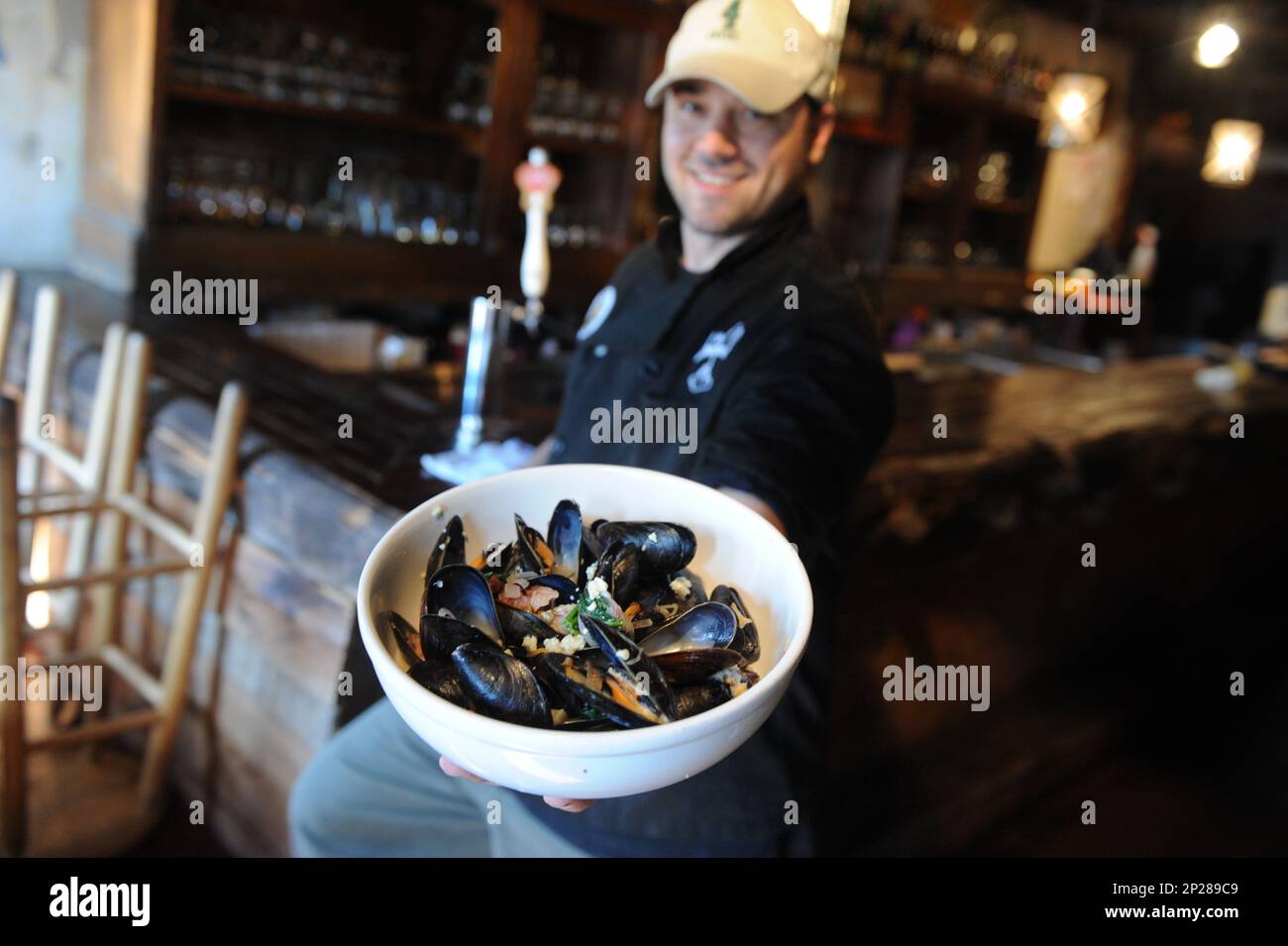Teddy Folkman, executive chef/owner of Granville Moore's, displays a ...