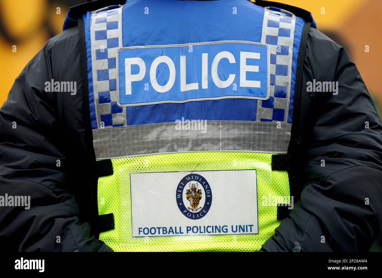 A close up of a police officers vest with the football policing unit ...