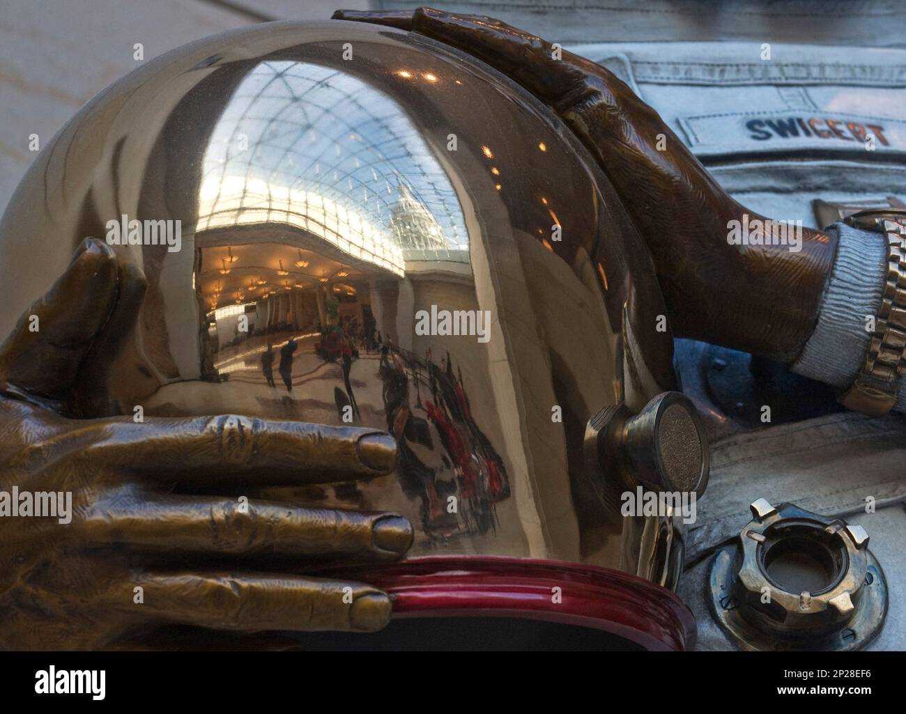 The Capitol dome reflects in the space helmet of the statue of ...